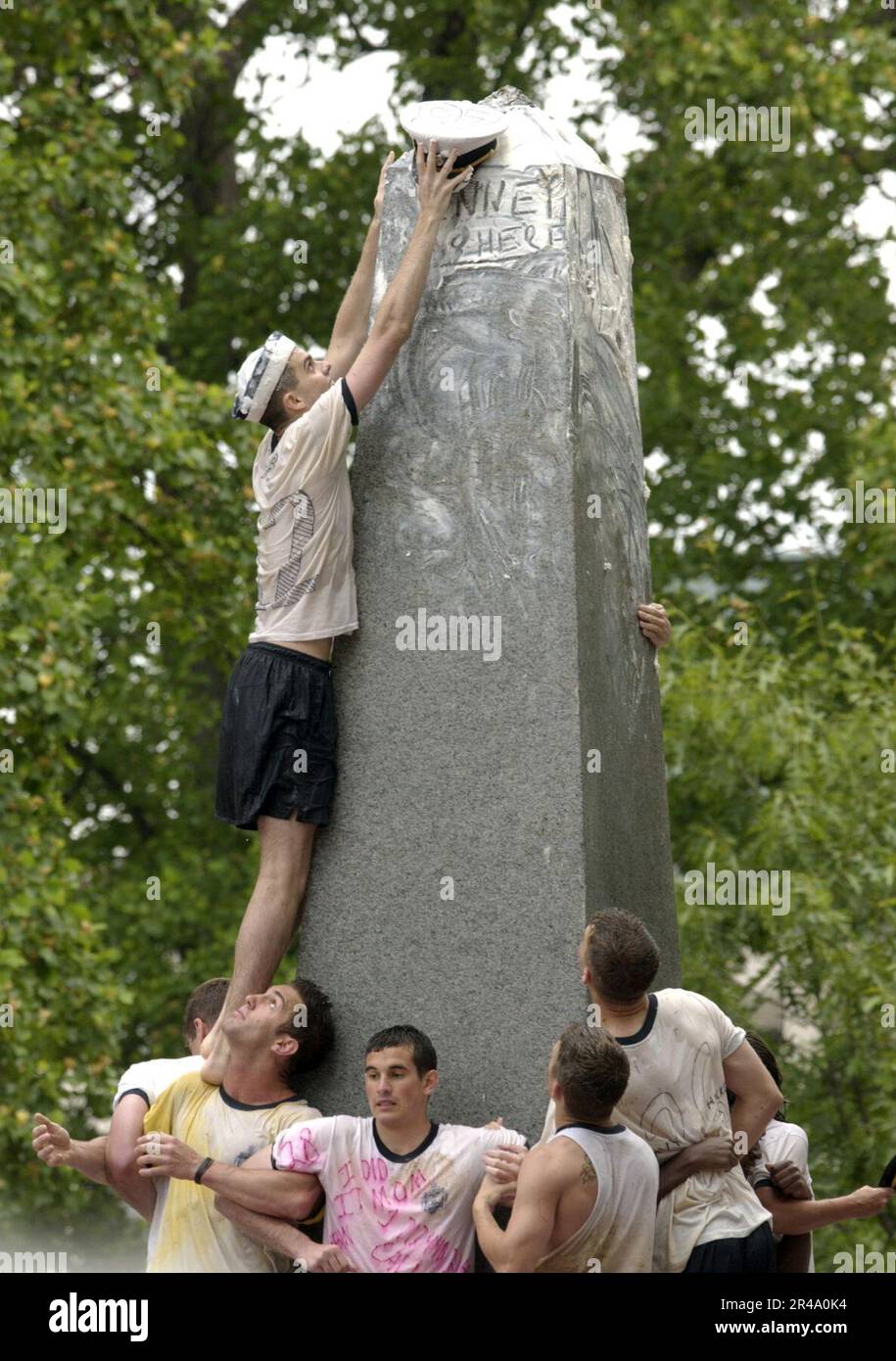 US Navy Midshipman Fourth Class Philip Johnson places a Midshipman's ...