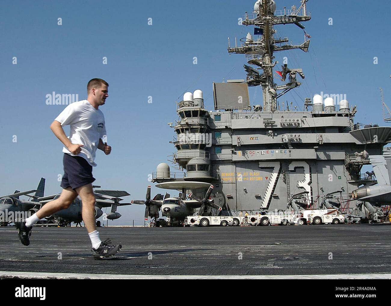 US Navy Lt. j.g. get in his exercise routine as he runs on the flight ...