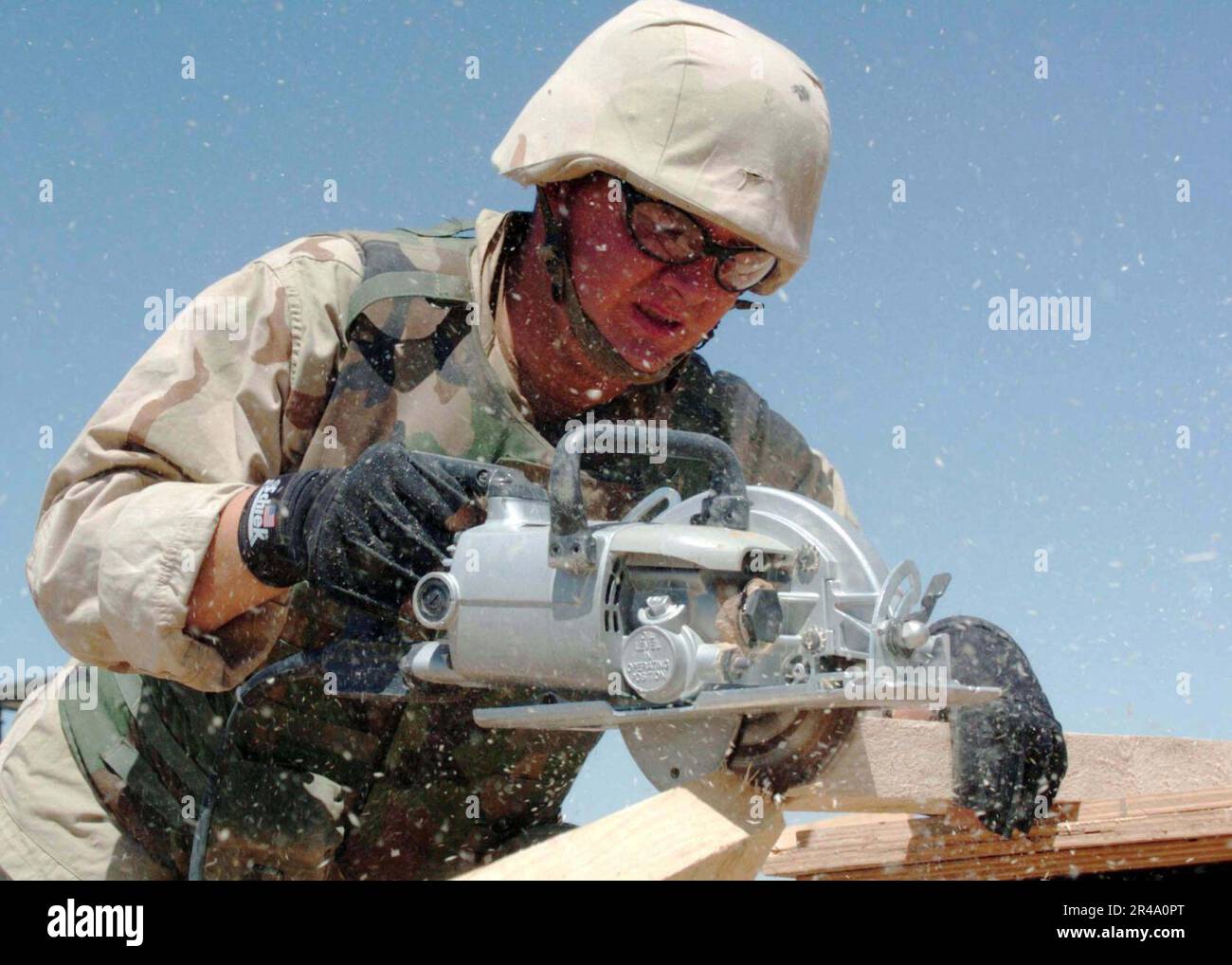 US Navy Builder Constructionman cuts 2x4 pieces of wood while ...