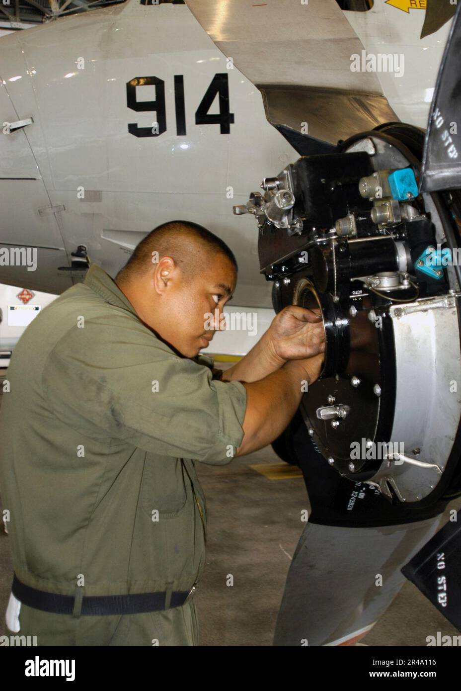 US Navy Aviation Machinist's Mate installs an O ring on the prop ...
