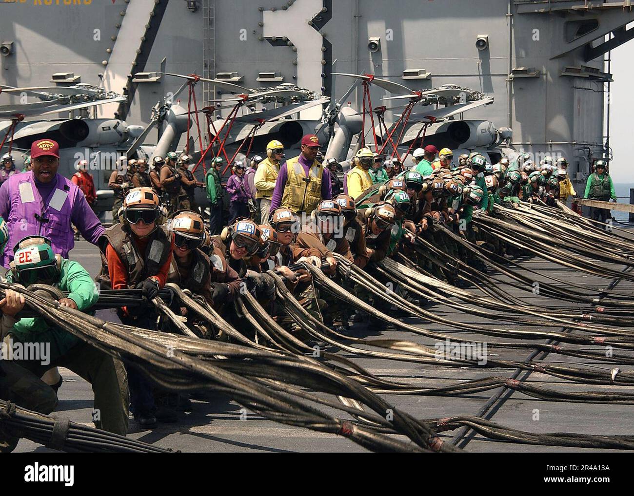 US Navy Air Department crew members practice rigging the emergency ...