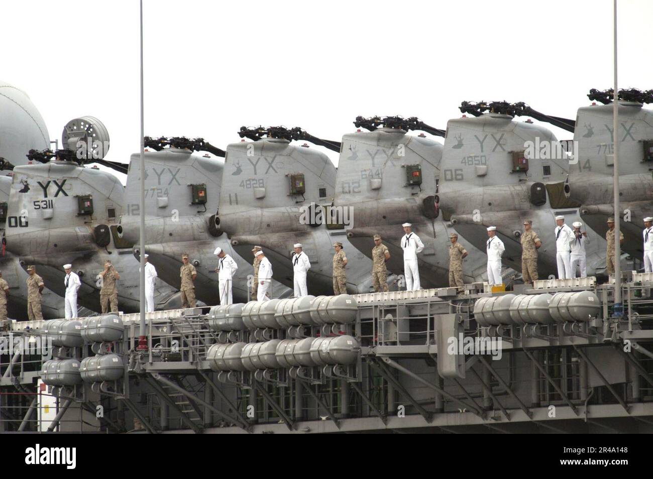 US Navy Sailors and Marines man the rails as the amphibious assault ...