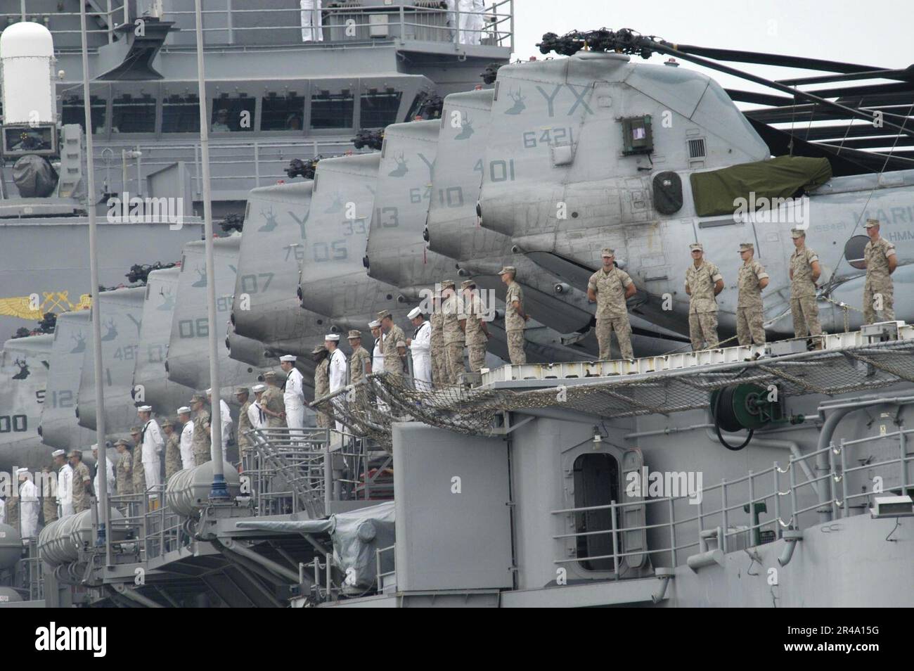 US Navy Sailors and Marines man the rails as the amphibious assault ...