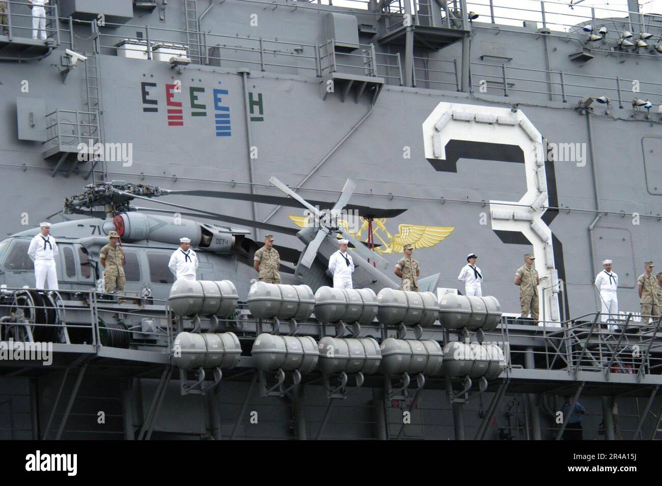 US Navy Sailors and Marines man the rails as the amphibious assault ...