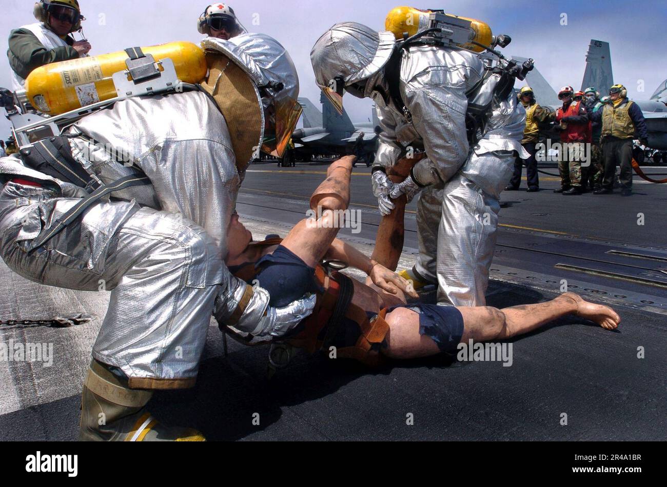 US Navy A flight deck Crash and Salvage crew move Oscar the training ...