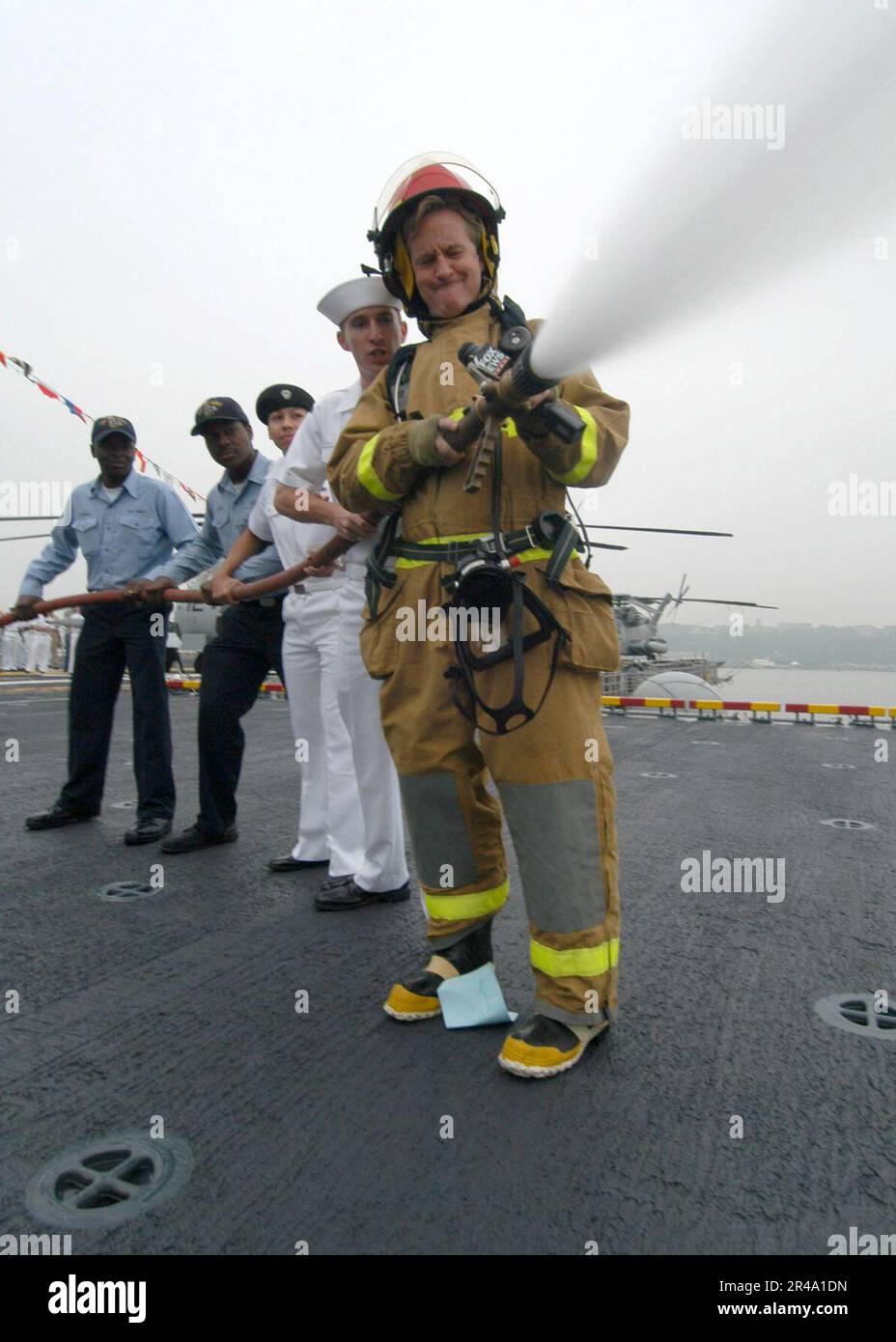 US Navy Steve Doocy of Fox News, demonstrates the proper use of a fire ...