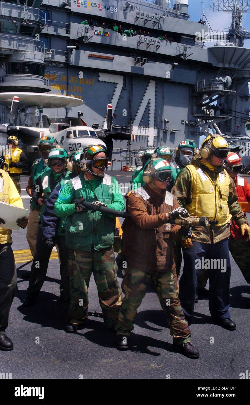 US Navy Sailors practice basic fire fighting techniques during flight ...