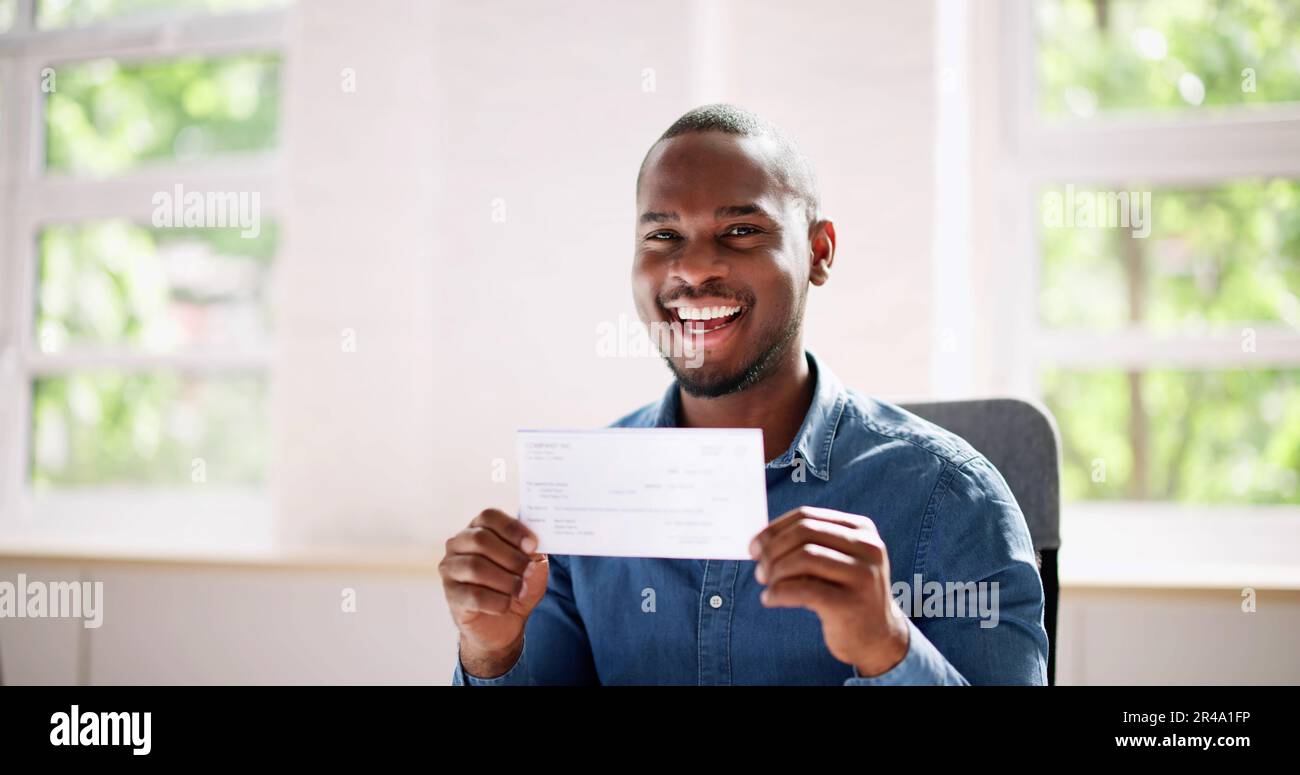 Black man holding cheque hi-res stock photography and images - Alamy