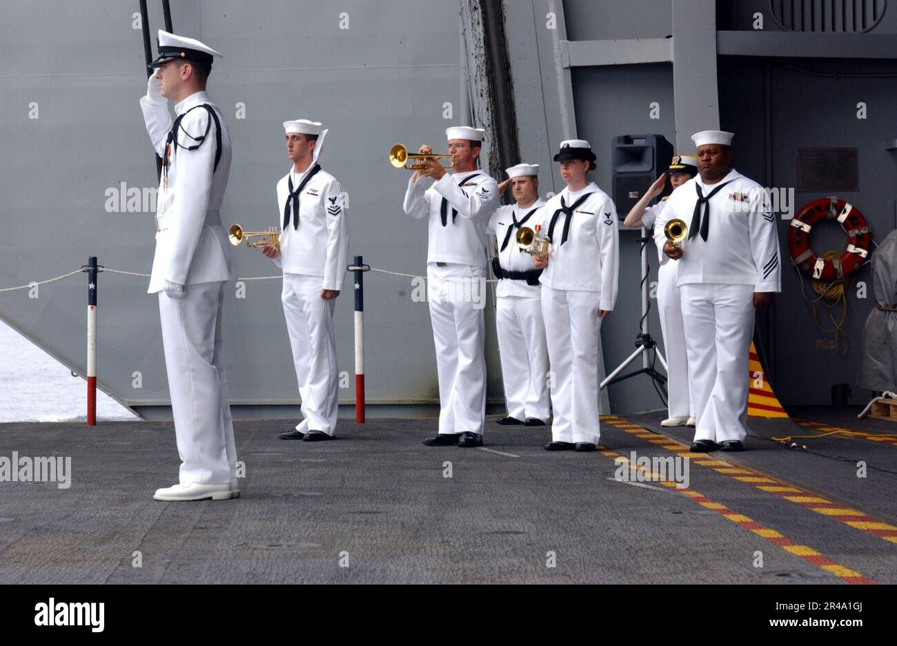 US Navy The Chief of Ceremonies renders a hand salute as one of the ...