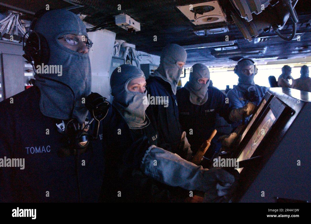 US Navy Master helmsman, stands watch on the bridge with helmsman under ...