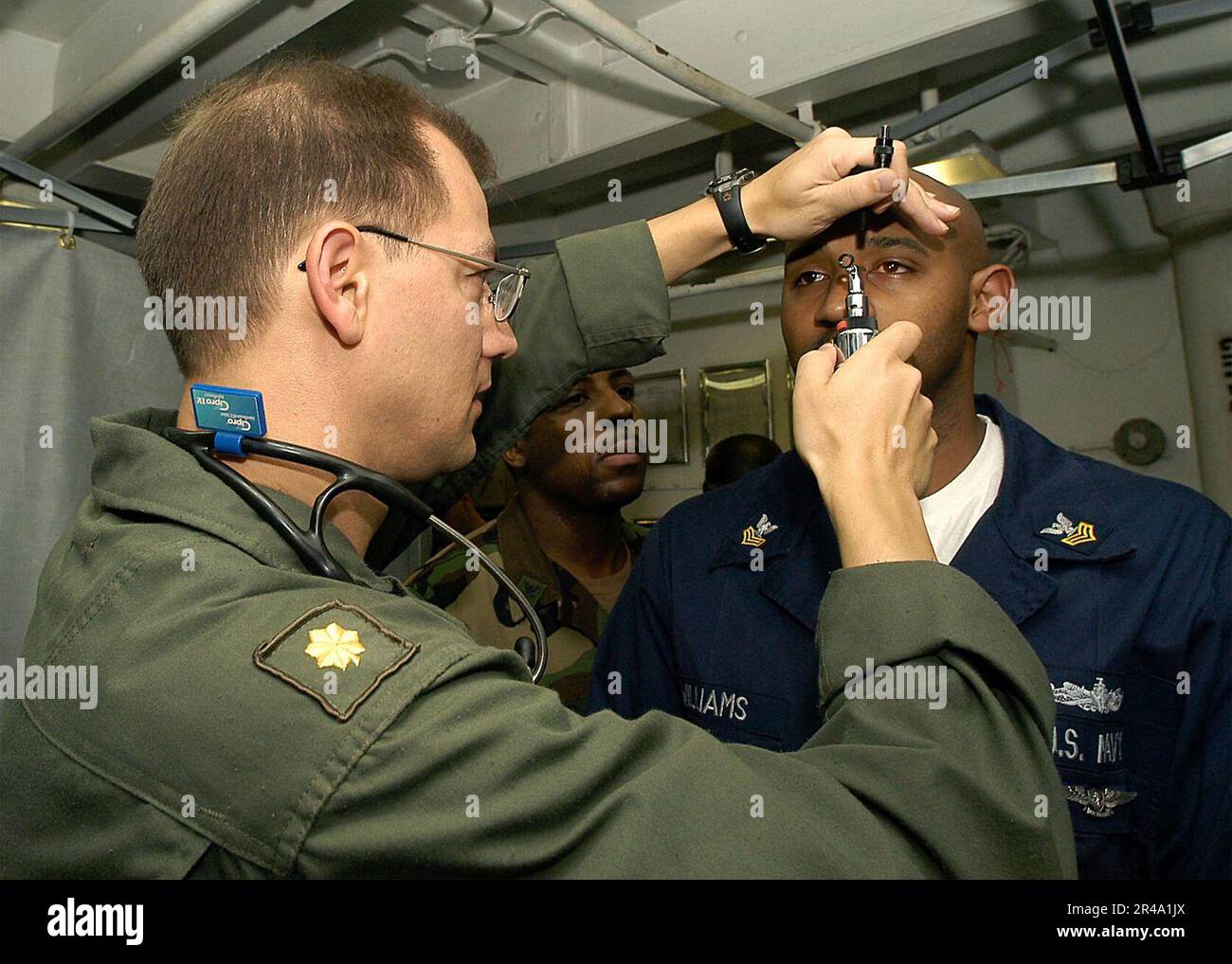 US Navy U.S. Navy Flight Surgeon, Lt. Cmdr. performs and eye ...