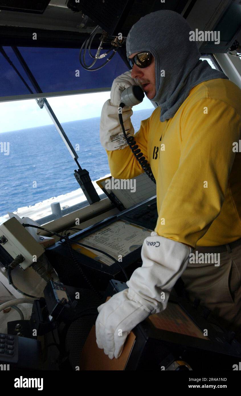 US Navy USS Ronald Reagan (CVN 76) Air Boss, Cmdr. communicates with ...