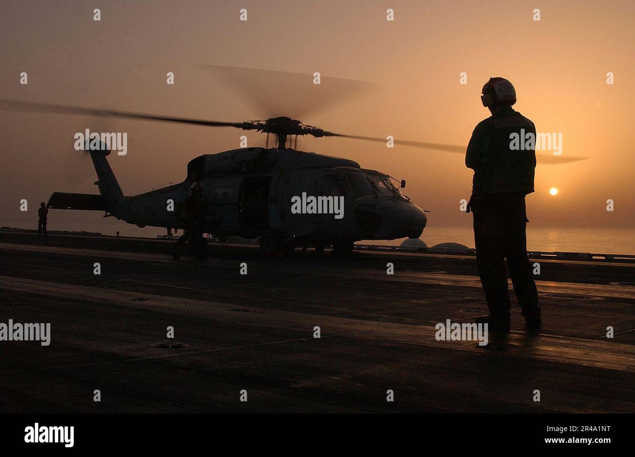 US Navy A Landing Signalman Enlisted (LSE) signals an SH-60F Seahawk on ...