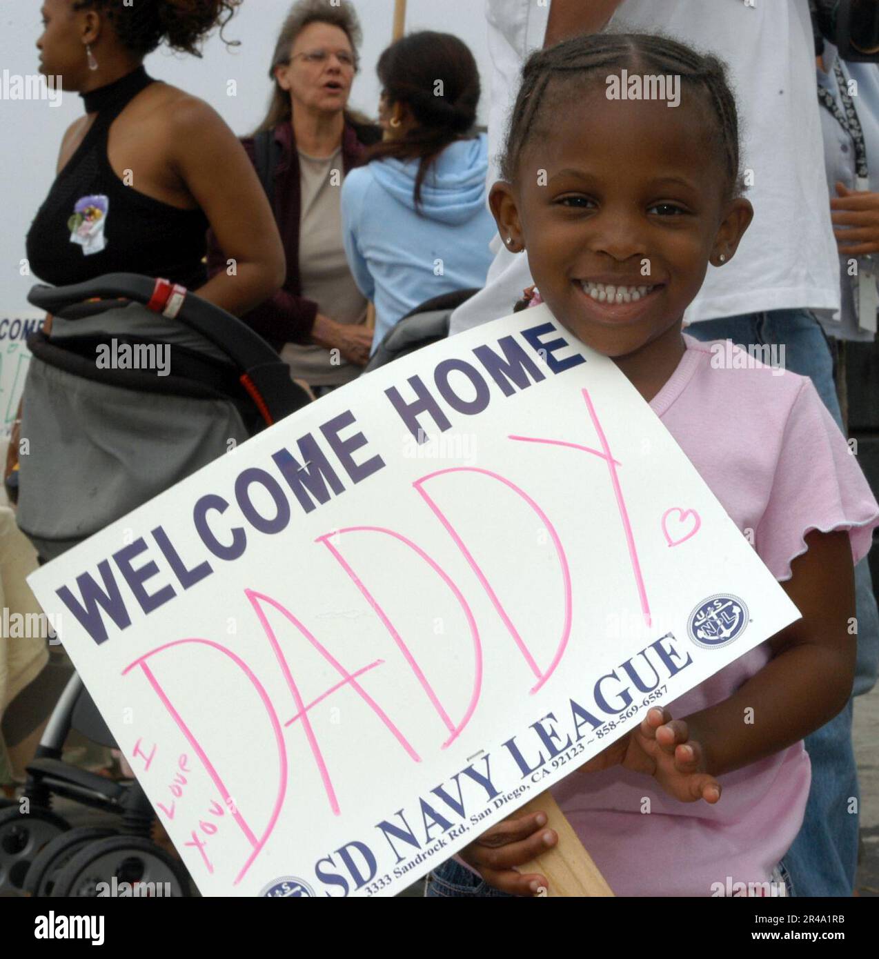 US Navy A loved one patiently waits for her father as his ship, the ...