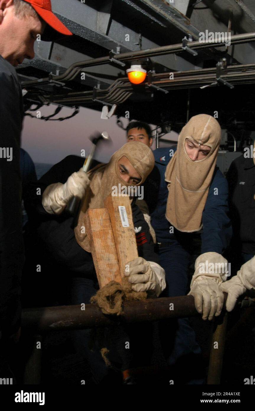 US Navy USS Abraham Lincoln (CVN 72) Sailors practice pipe patching ...
