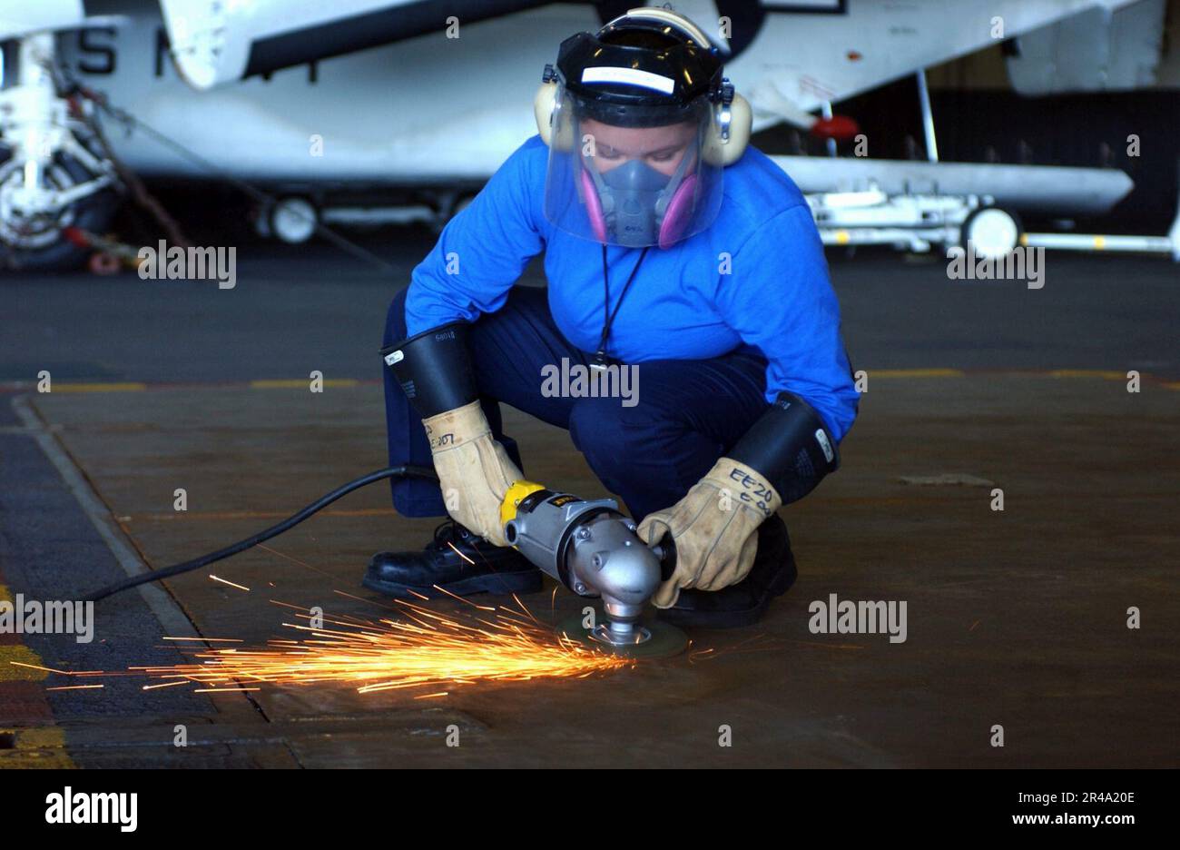 US Navy Airman grinds non-skid from a weapons elevator door Stock Photo ...
