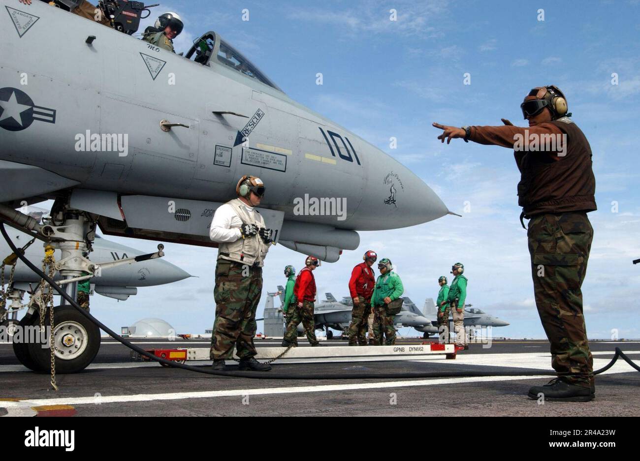 US Navy Airman right, assigned to the Swordsmen of Fighter Squadron ...