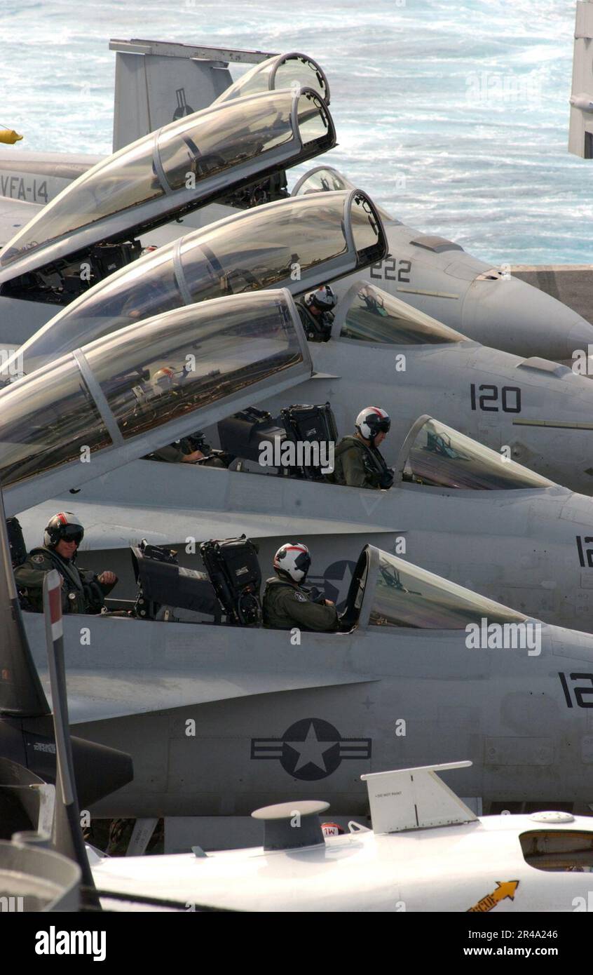 US Navy Pilots and aircrew complete preflight check on their F-A-18F ...