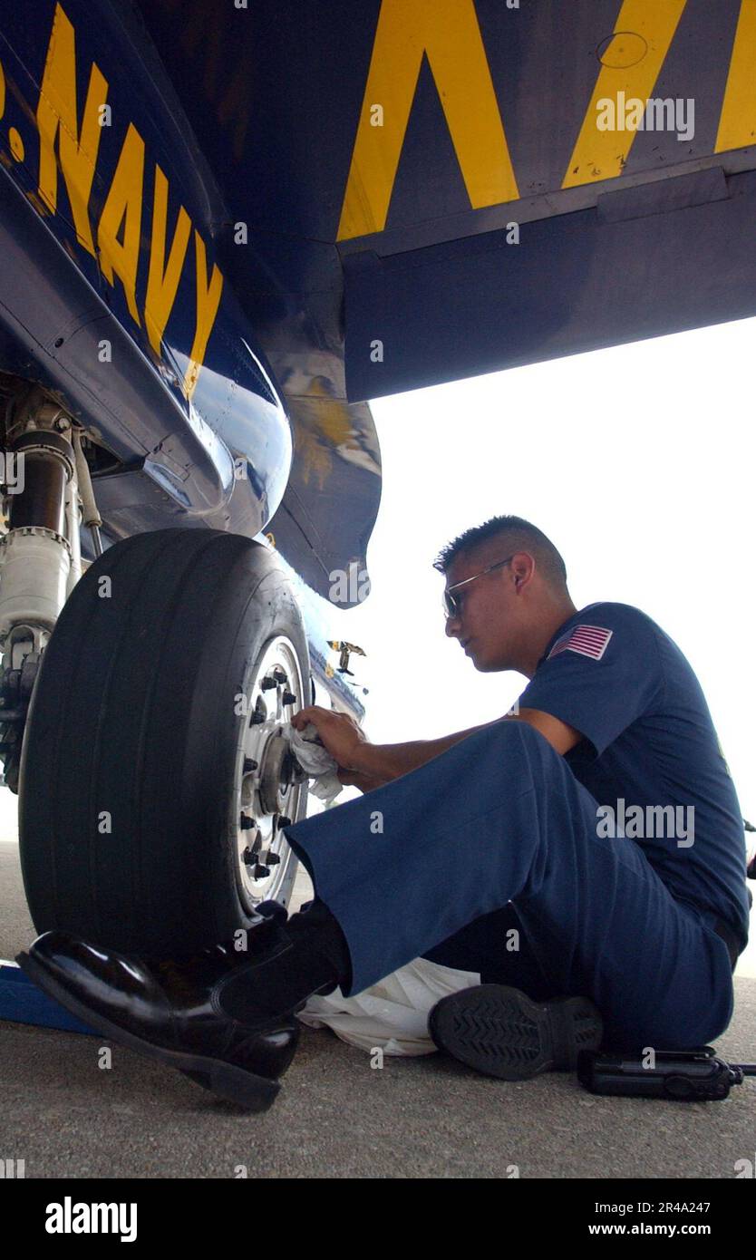 US Navy Aviation Structural Mechanic 1st Class wipes brake dust from ...