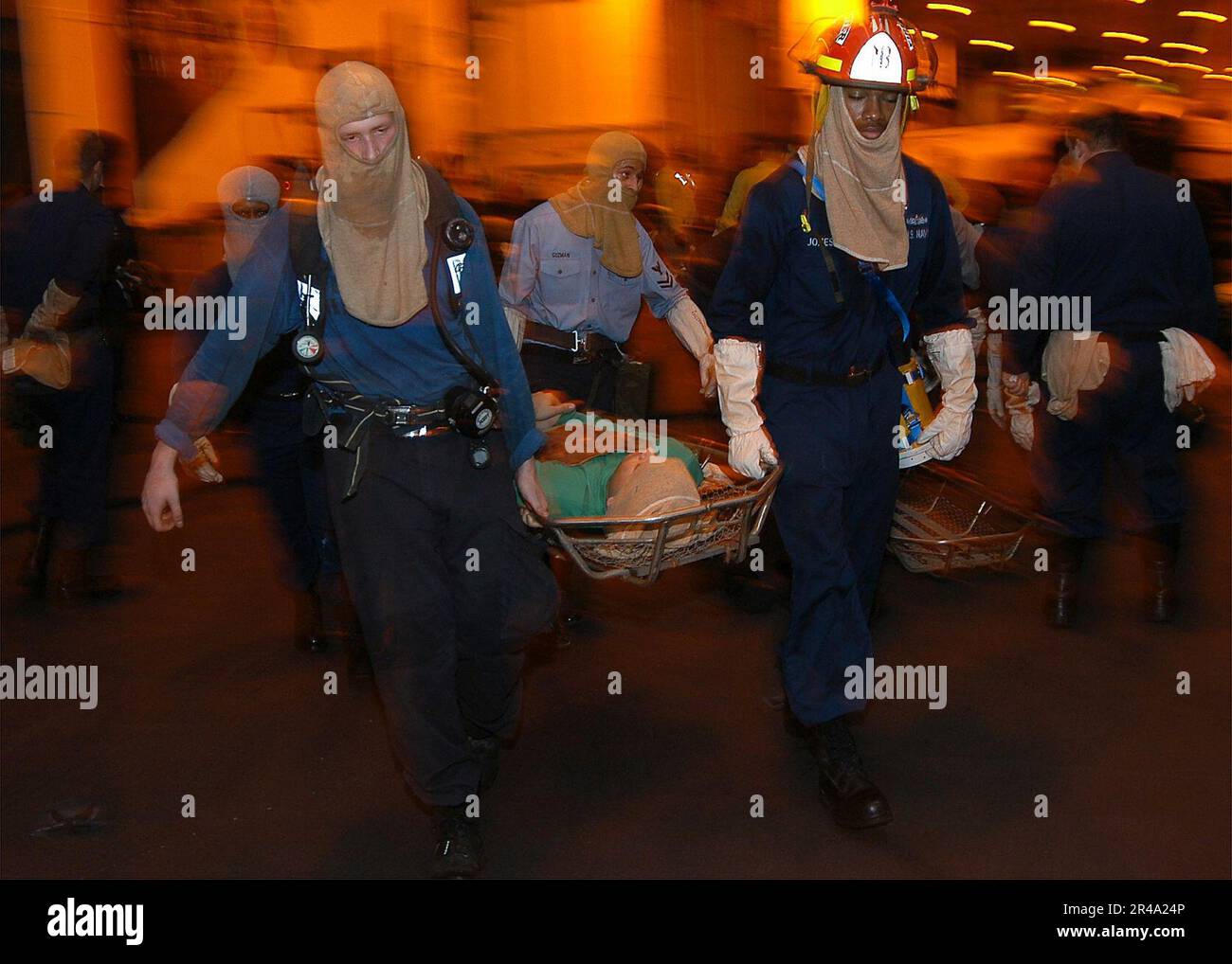 US Navy Repair locker stretcher bearers carry simulated injured ...