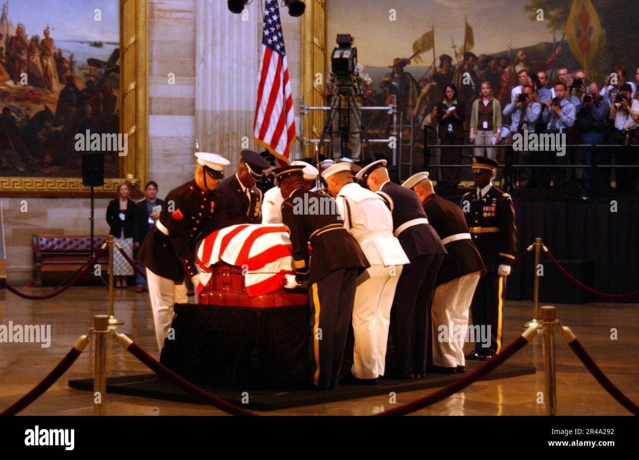US Navy Ceremonial Honor Guard prepare to move the flag-draped casket ...