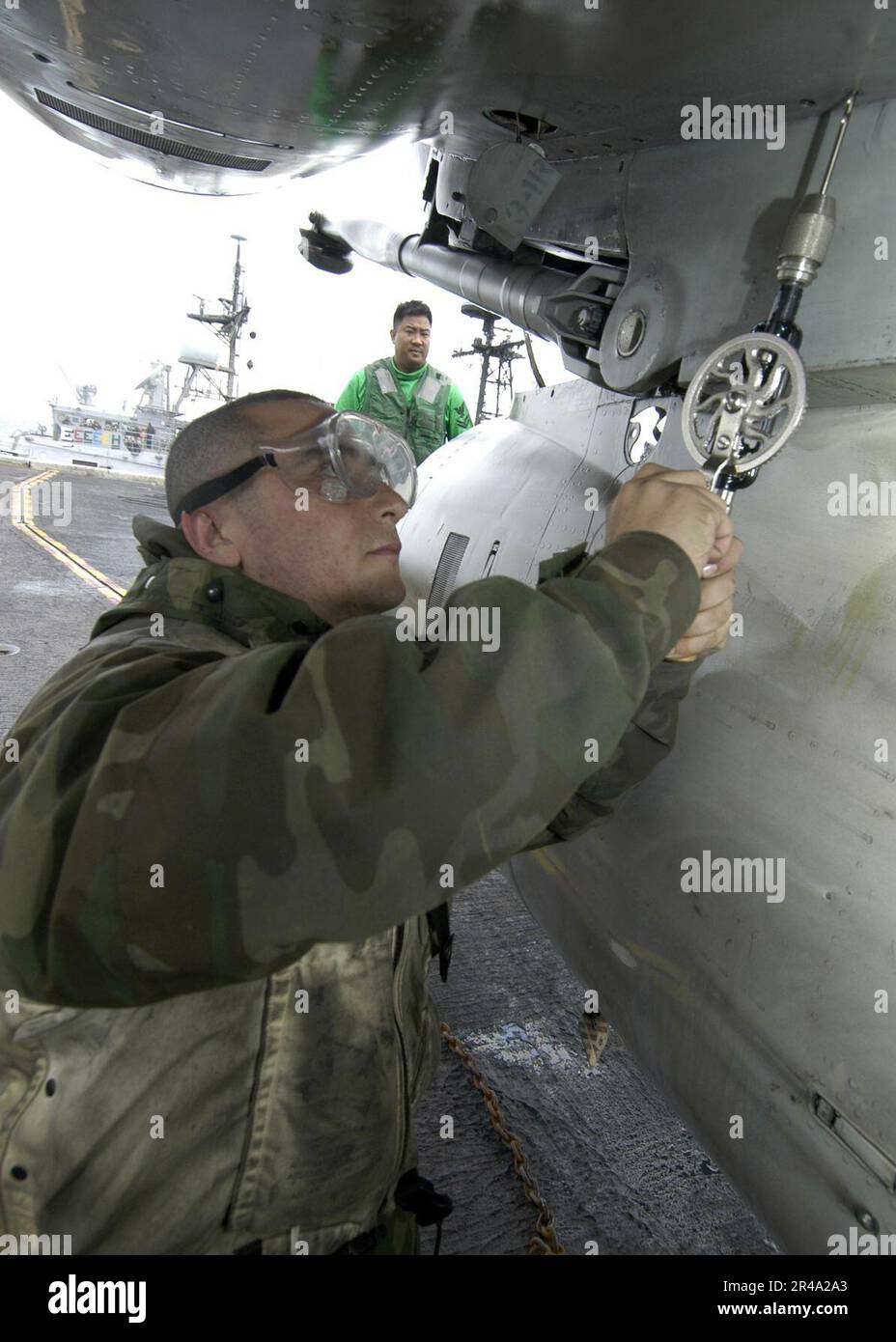 US Navy Aviation Structural Mechanic Airman performs a maintenance ...