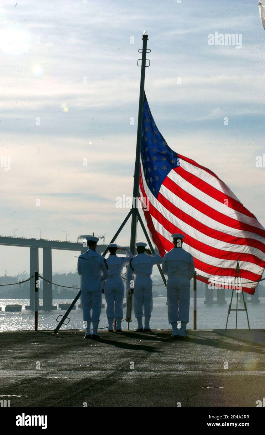 US Navy USS Ronald Reagan (CVN 76) Sailors salute the American flag ...