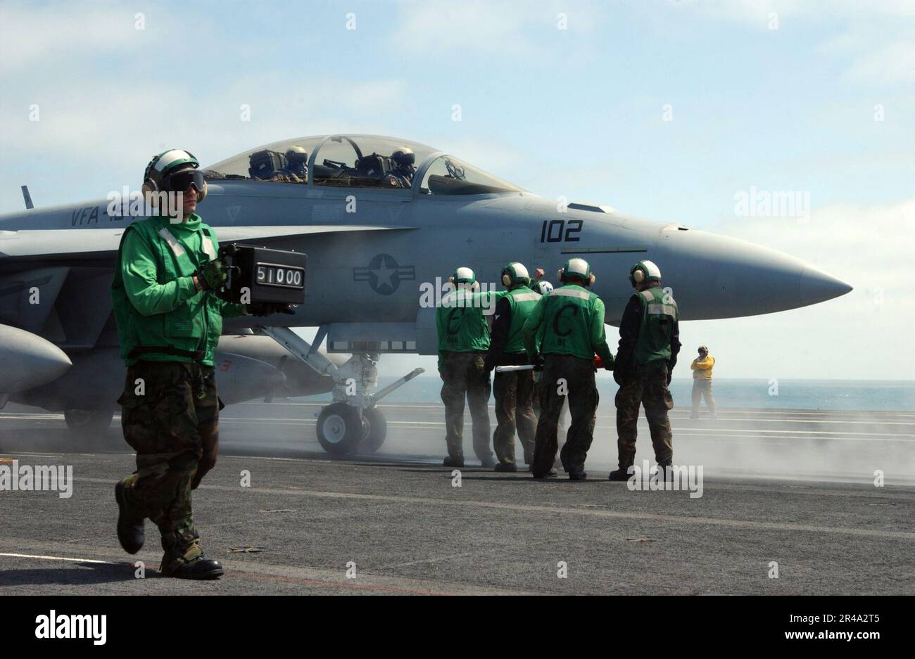 US Navy A Catapult Weight Board Operator relays the weight of an F-A ...