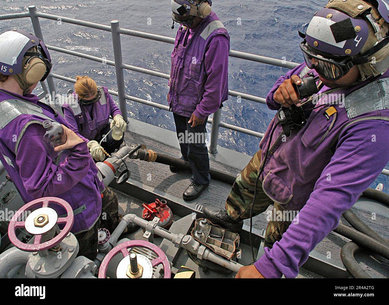 US Navy Sailors from the Aviation Fuels Division check a sample of JP-5 ...