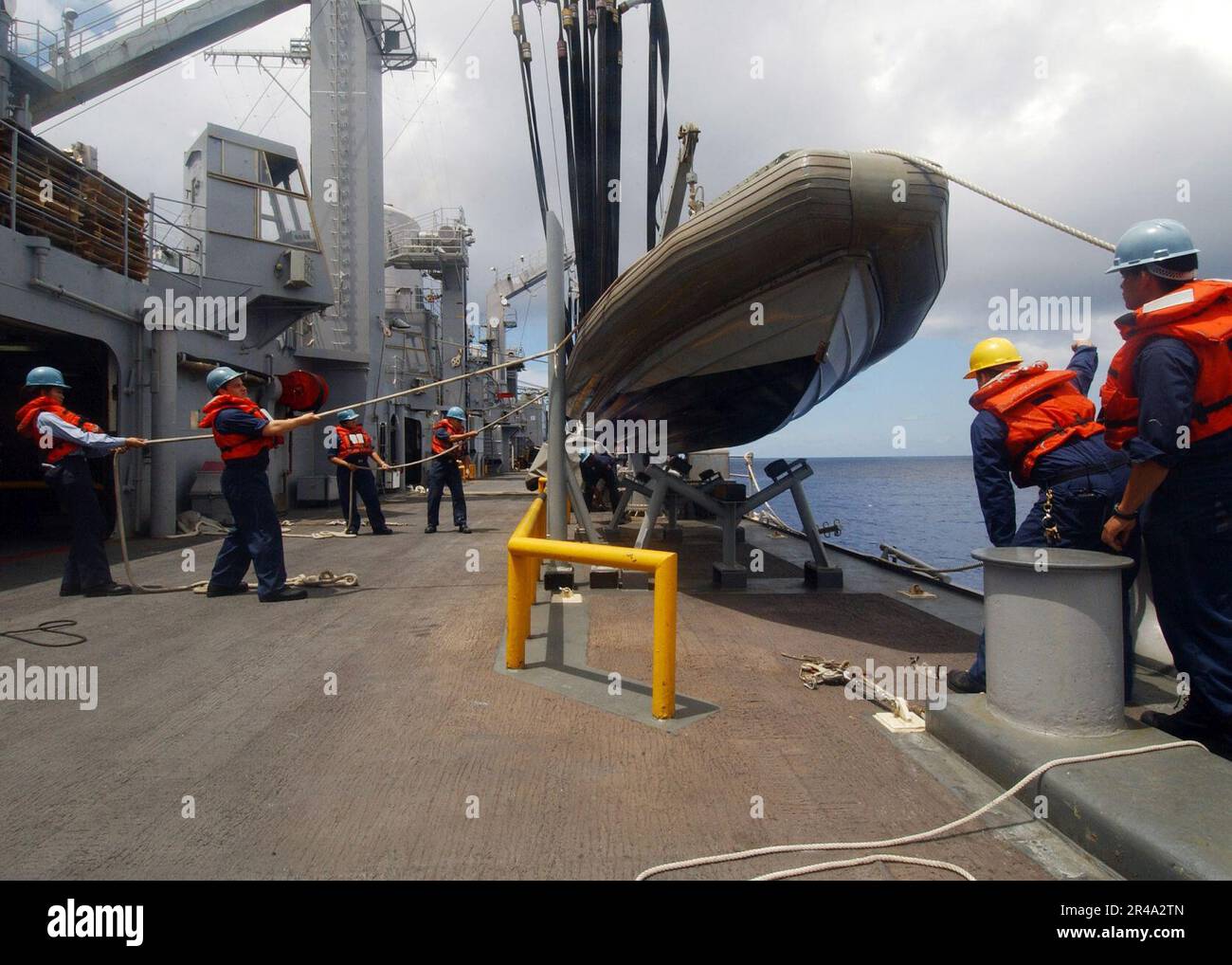 US Navy Sailors assigned to the fast combat support ship USS Seattle ...