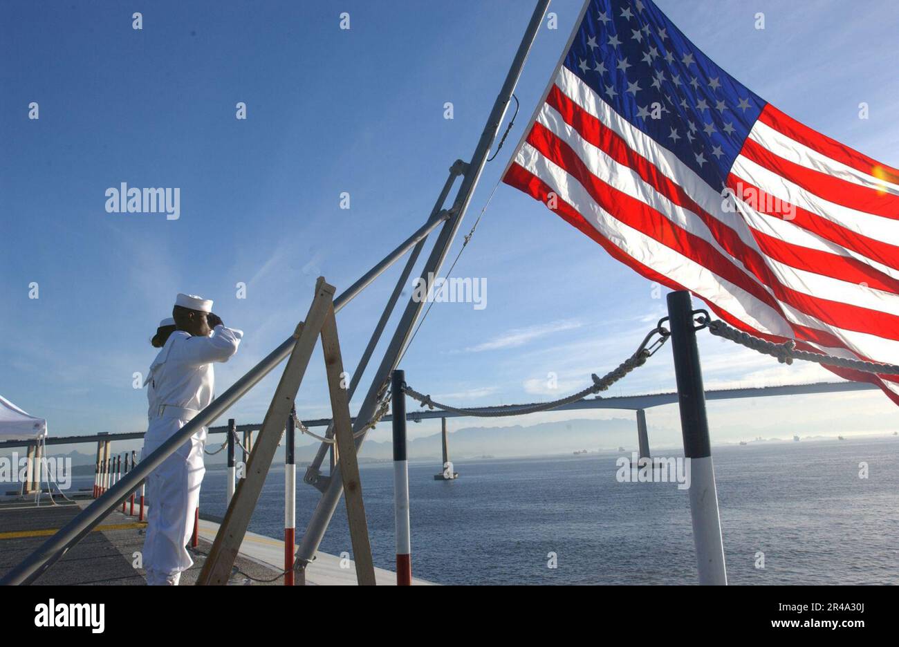 US Navy USS Ronald Reagan (CVN 76) Sailors salute the American flag ...