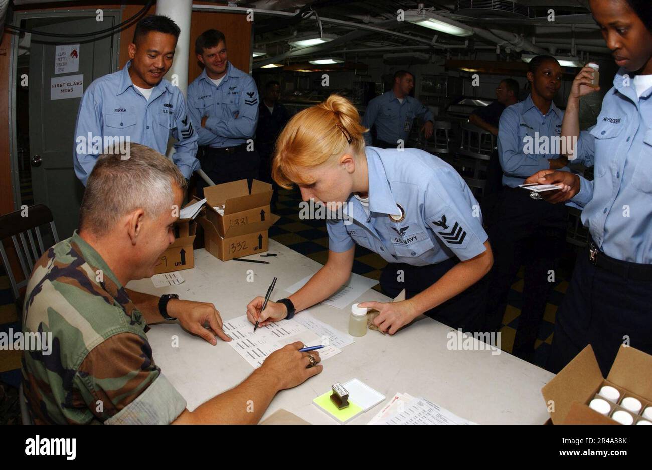 US Navy Crew members undergo a command-wide urinalysis screening aboard ...