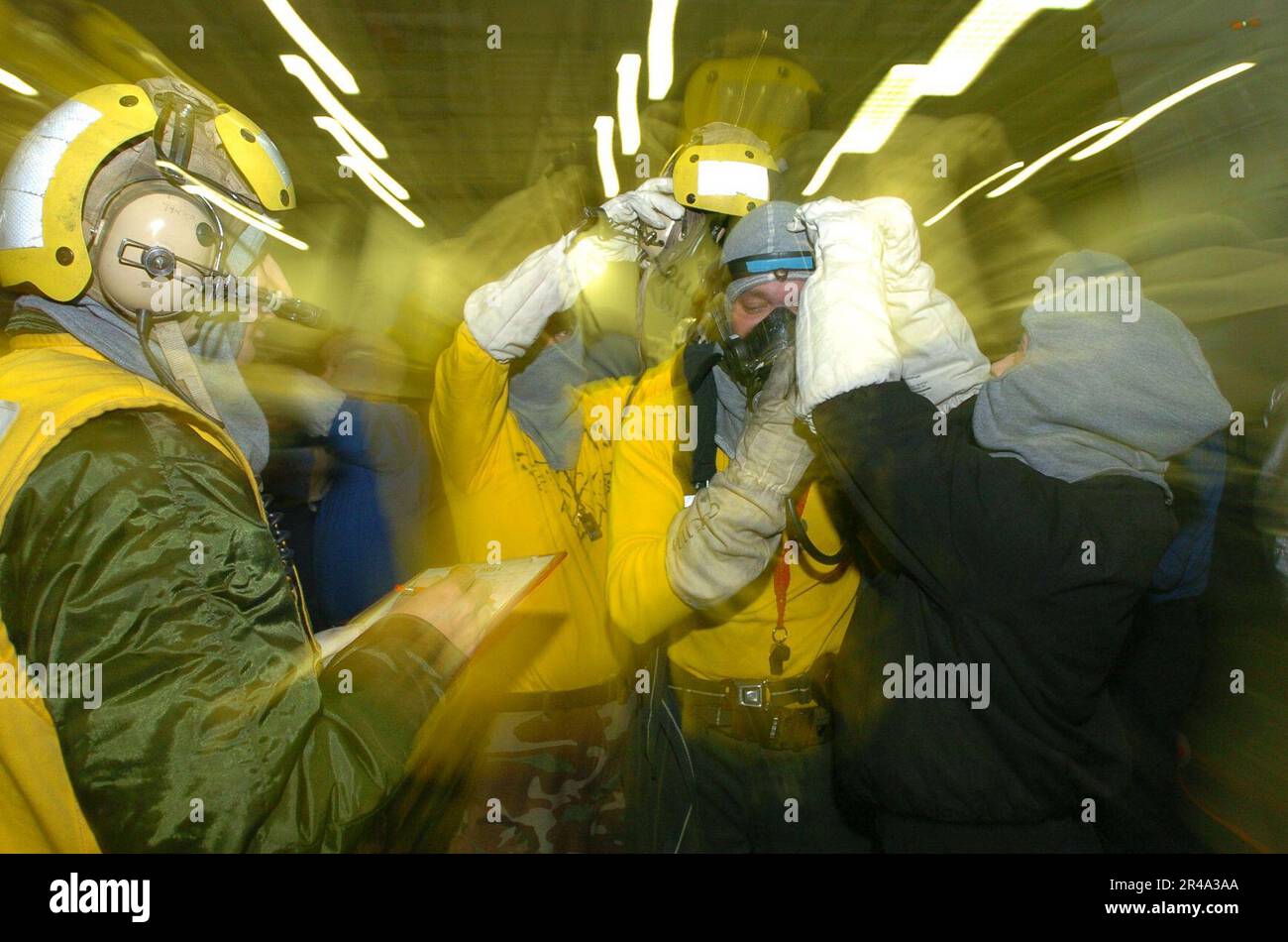 US Navy Repair party members discuss tactics while getting dressed out ...