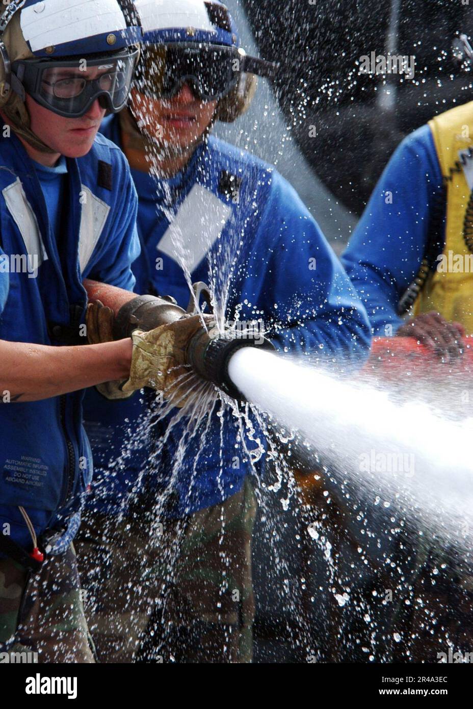 US Navy Aviation Boatswain's Mates practice using a fire hose, while ...