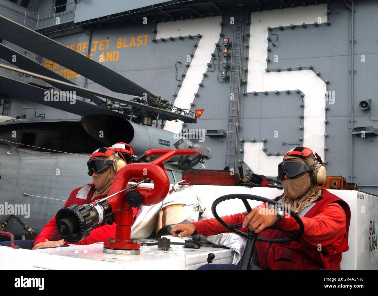 US Navy Sailors assigned to Crash and Salvage aboard the Nimitz-class ...