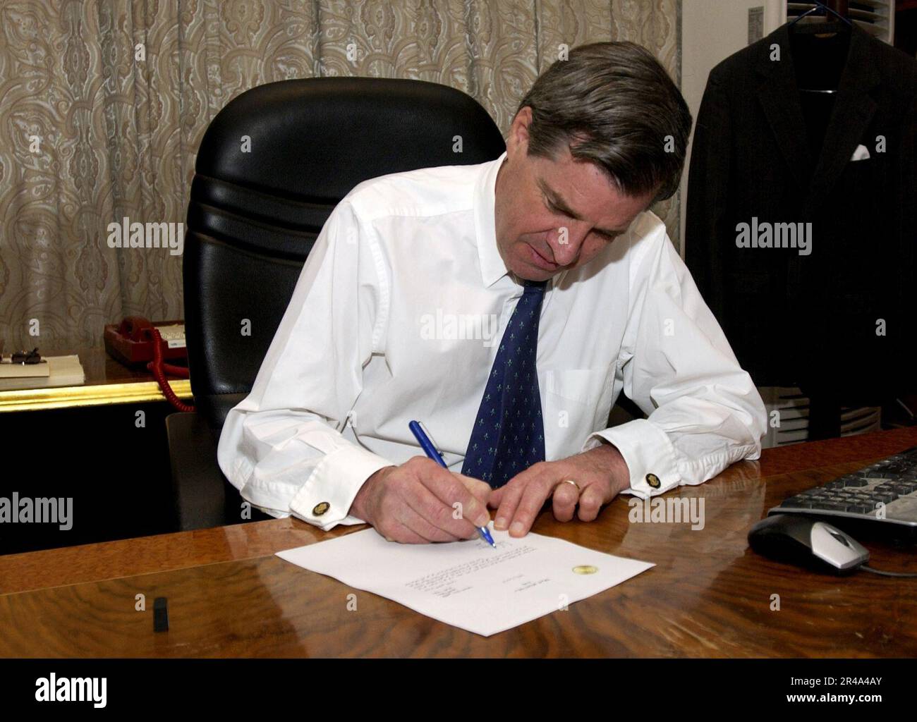 US Navy Ambassador L. Paul Bremer signs the Iraqi Sovereignty document ...