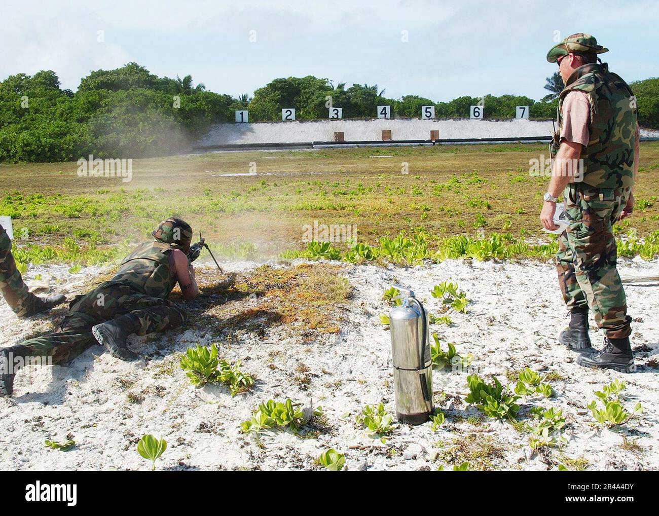 US Navy Master-at-Arms Seaman Apprentice fires an M-60 Machine Gun down ...