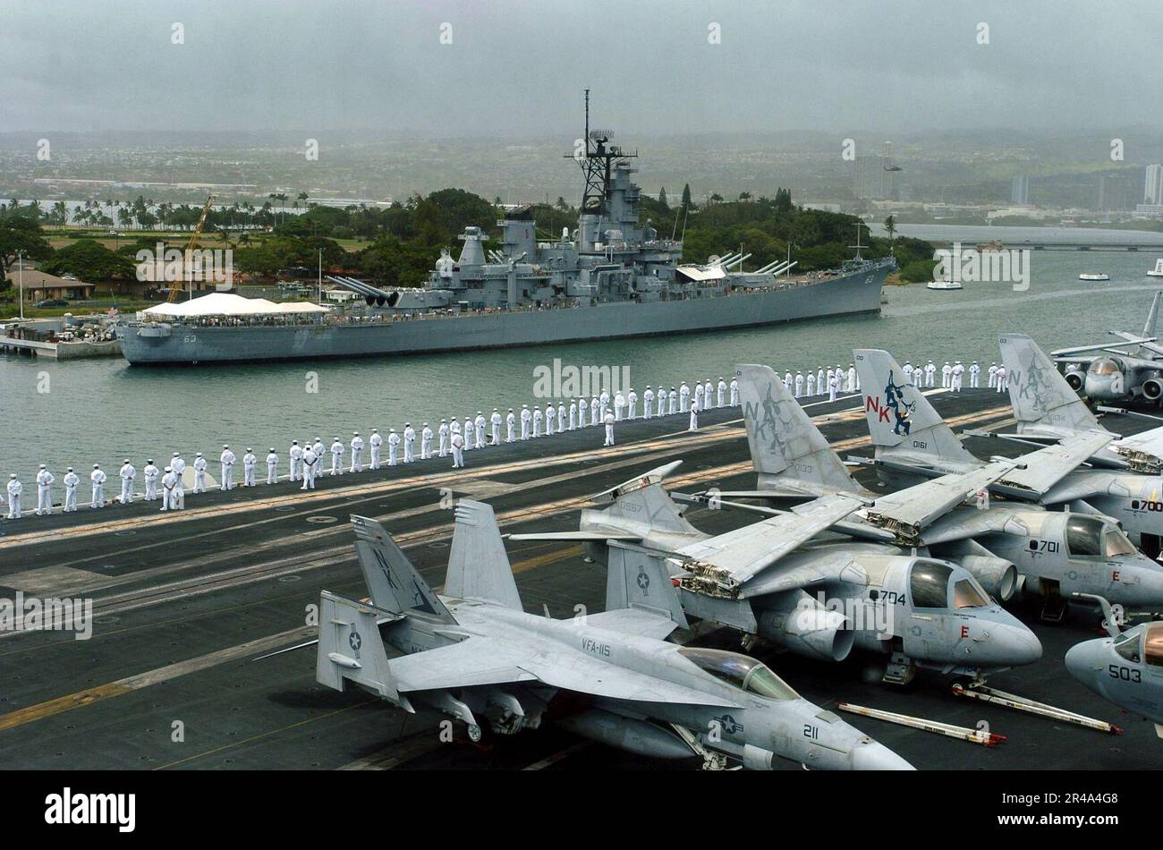 US Navy Sailors man the rails aboard the Nimitz-class aircraft carrier ...