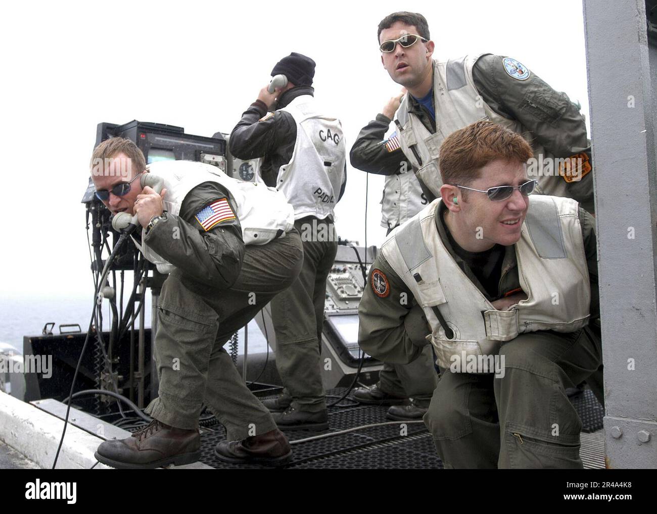 US Navy Landing Signal Officers LSO pay close attention to an aircraft ...