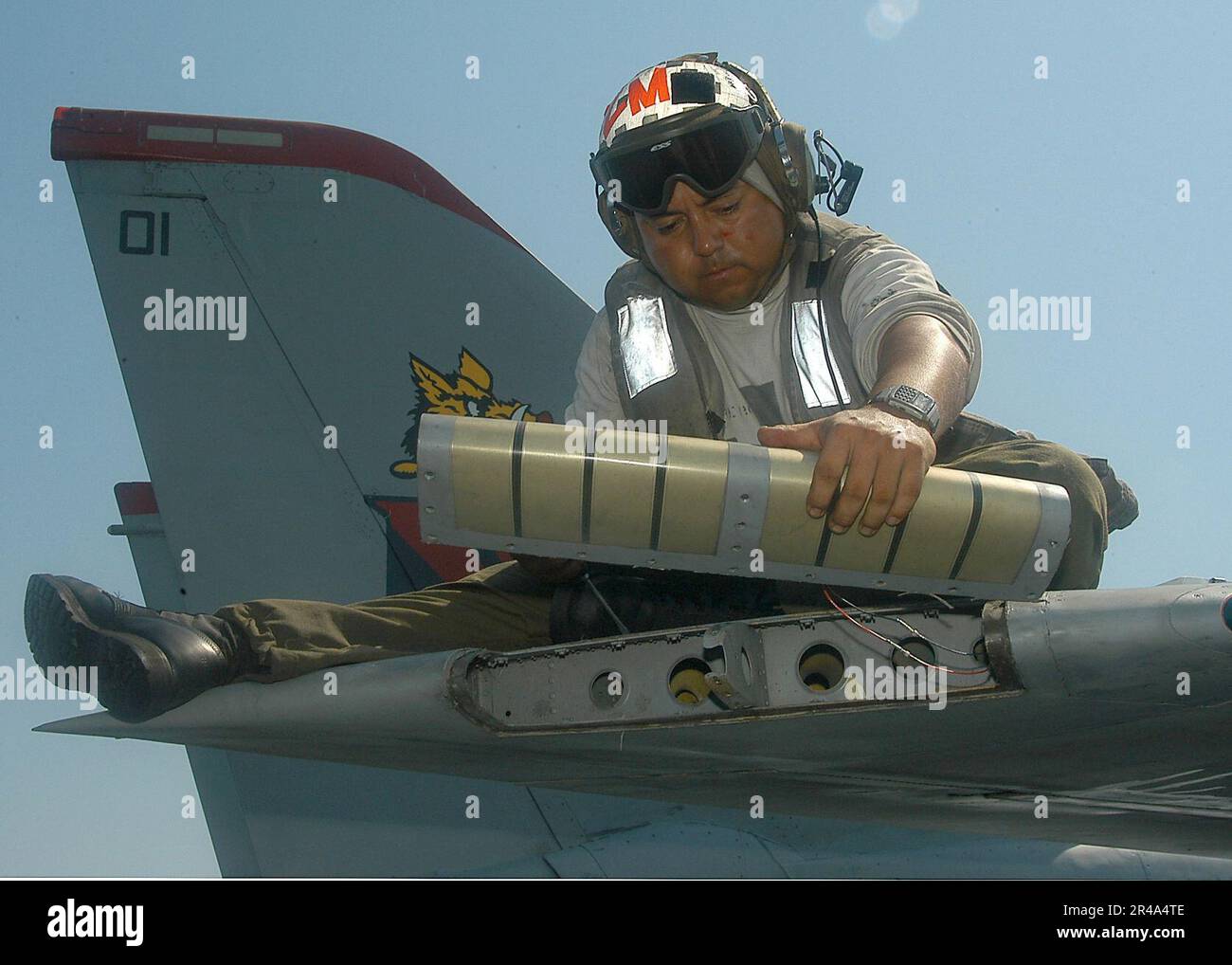 US Navy Aviation Structural Mechanic 1st Class performs maintenance on ...