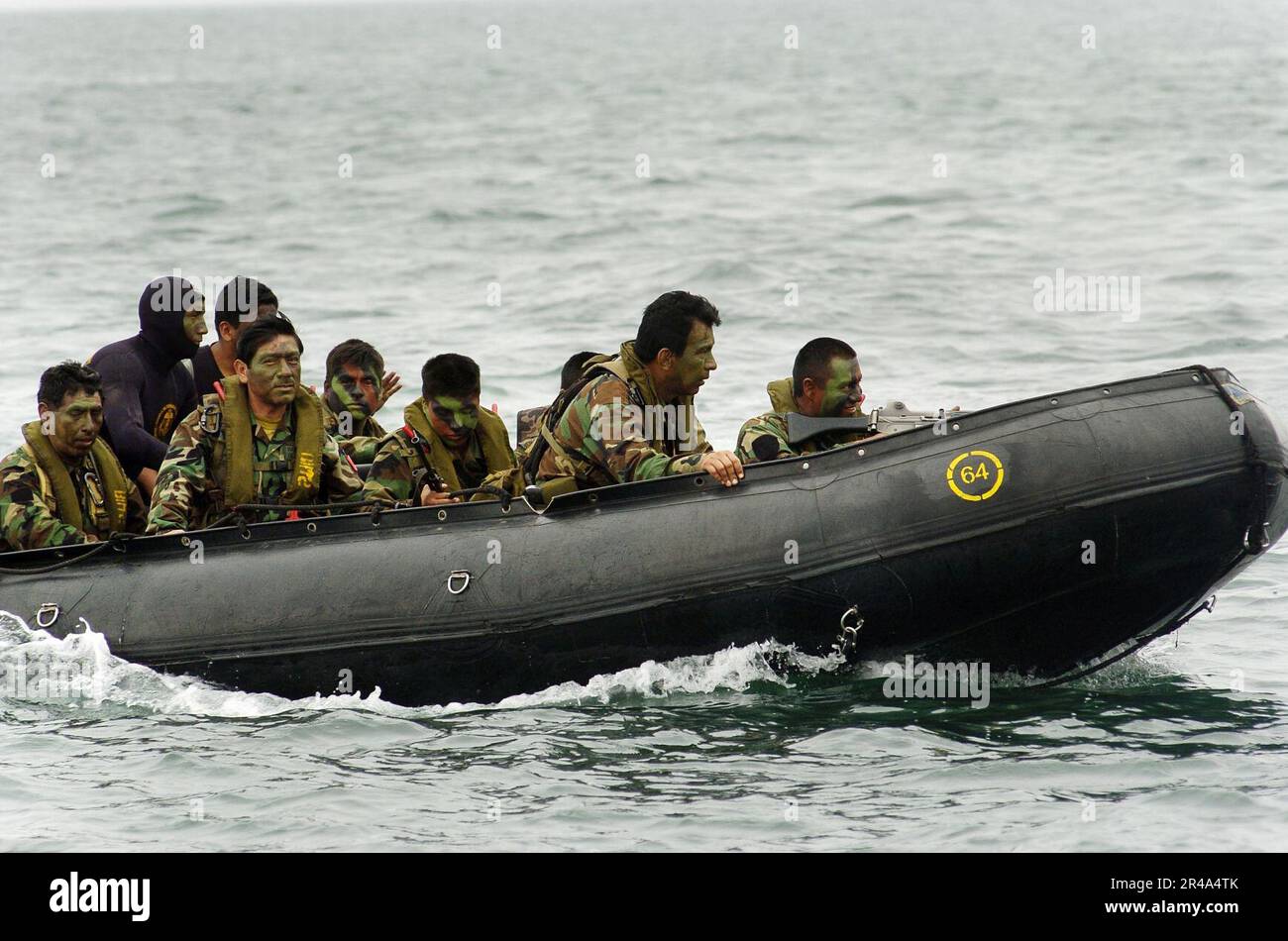 US Navy Peruvian Commandos approach the beach in a zodiac boat during ...