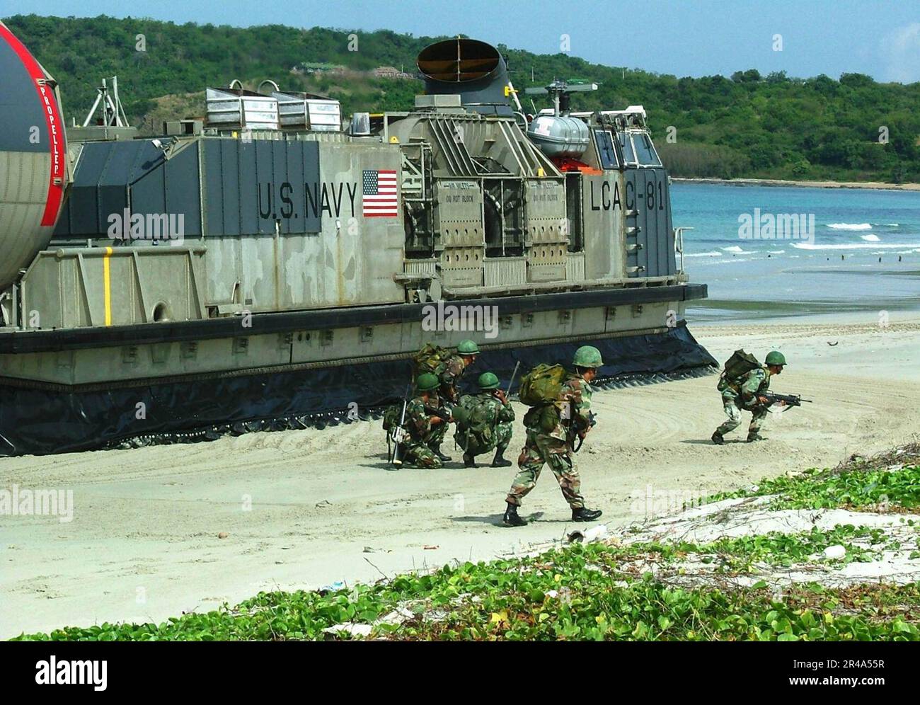 US Navy Royal Thai Marines storm ashore from a U.S. Navy Landing Craft ...