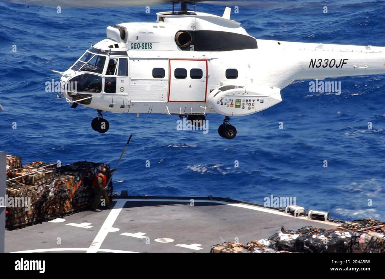 US Navy An SA 330J Puma helicopter hovers above the Combat Stores Ship ...