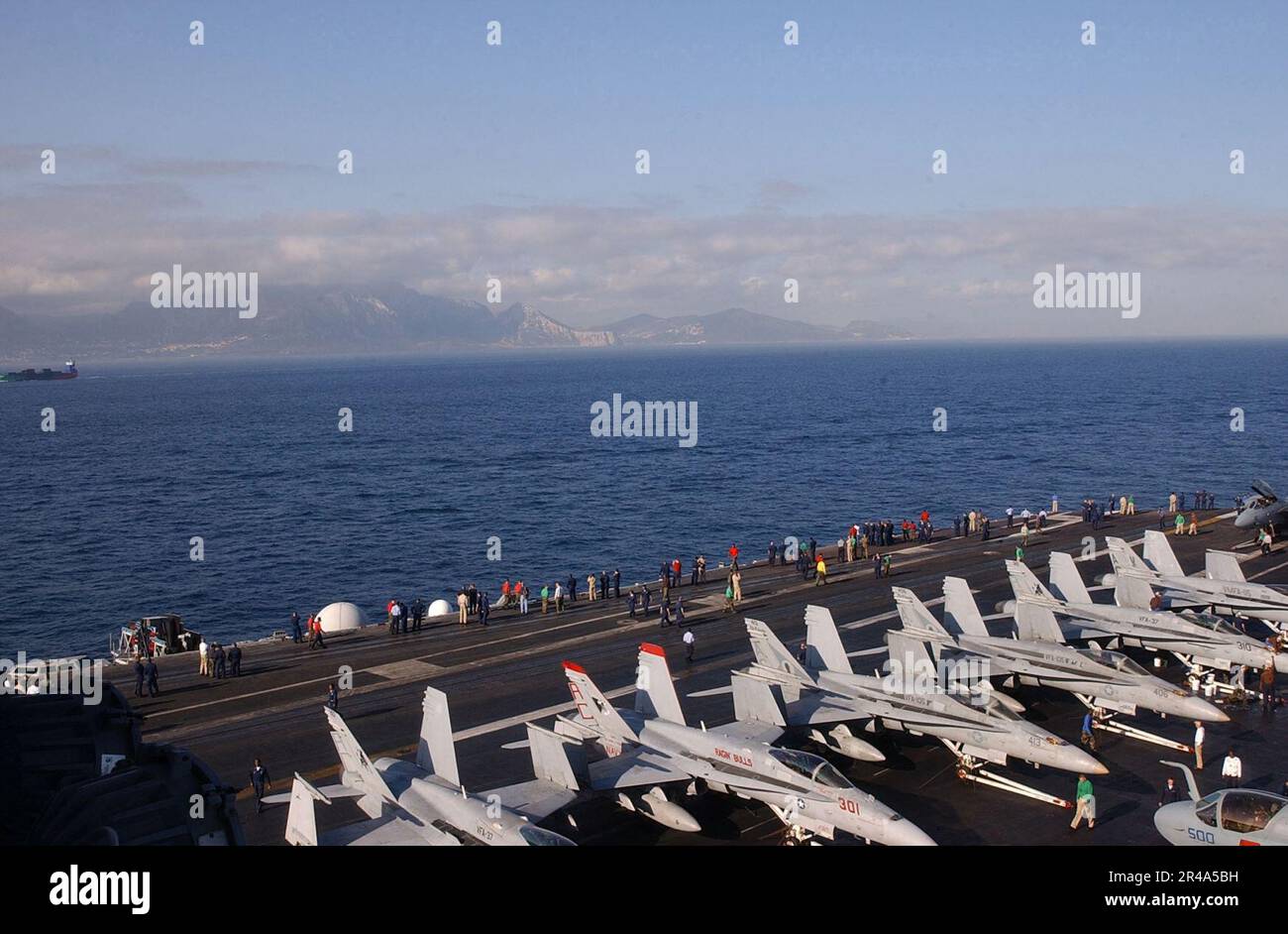 US Navy Sailors line the port side of USS Harry S. Truman (CVN 75) as ...