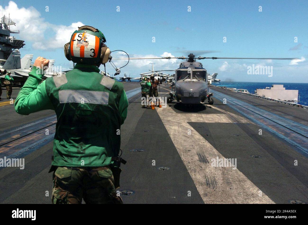 US Navy A Landing Signal Enlisted (LSE), directs a South Korean ...