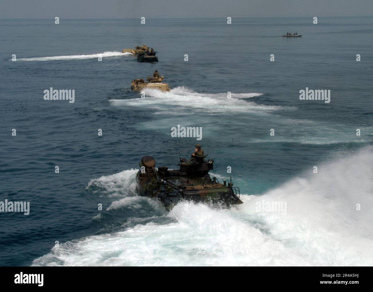 US Navy Amphibious Assault Vehicles (AAV) speed through the water after ...
