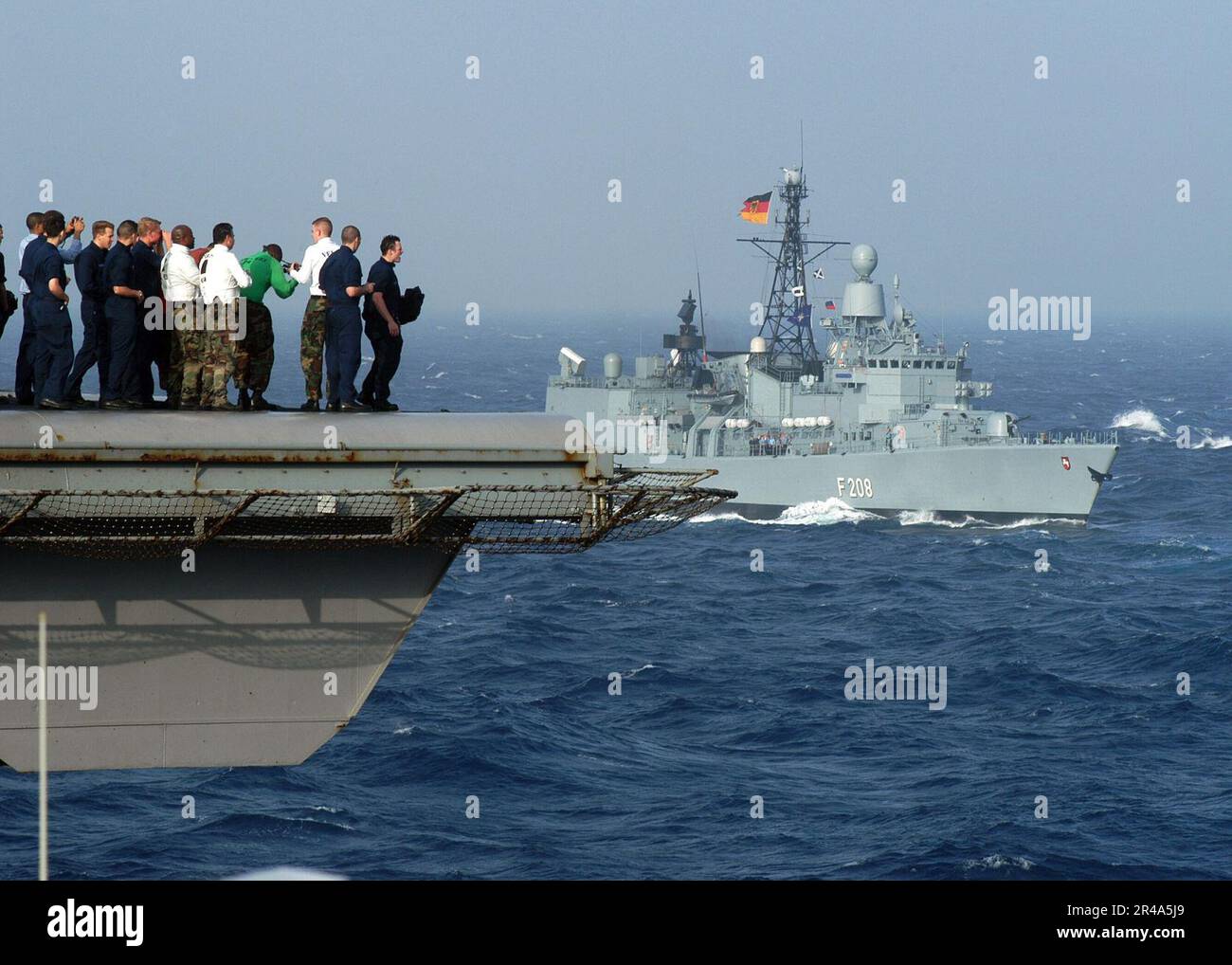 US Navy Sailors gather on the flight deck of the aircraft carrier USS ...