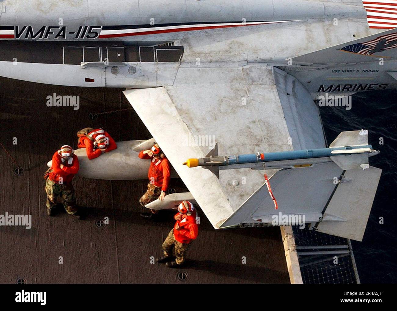 US Navy Ordnancemen stand by on the flight deck during flight ...