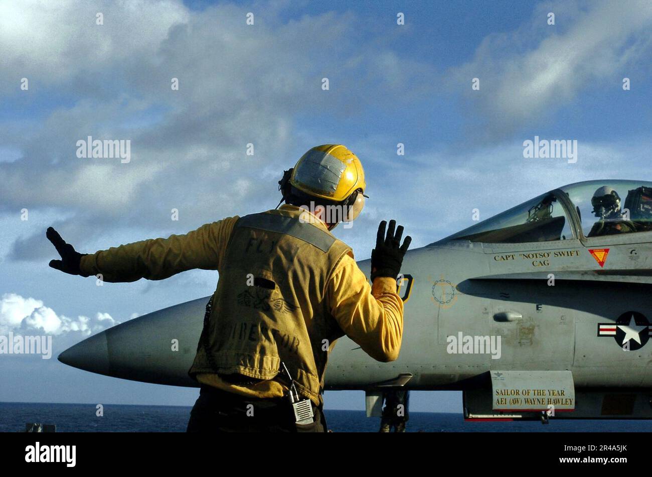US Navy An Aviation Boatswain's Mate Handler directs an F-A-18C Hornet ...