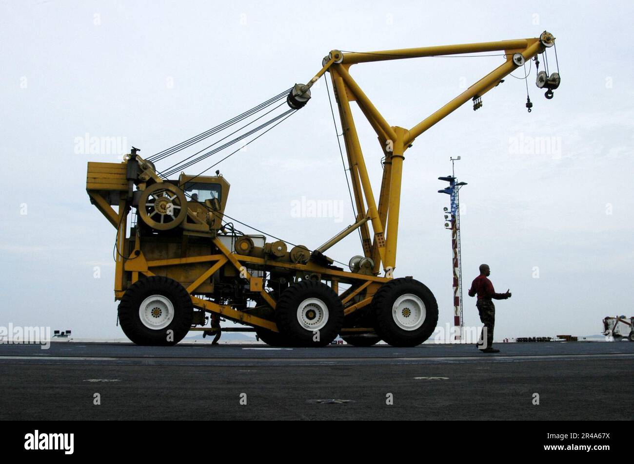 US Navy Crash and Salvage personnel aid in repositioning the flight ...